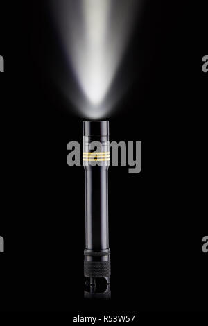 Image of a black metal pocket flashlight with a clip on a white ...