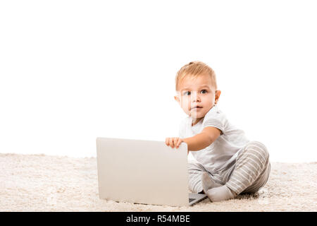 Cute baby with laptop on the white bed Stock Photo - Alamy
