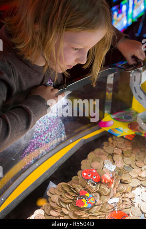 A 'coin pusher' slot machine in an amusement arcade, UK Stock Photo ...
