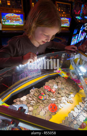 A 'coin pusher' slot machine in an amusement arcade, UK Stock Photo ...