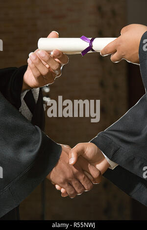 Hand shake, graduation and certificate for college student with ...