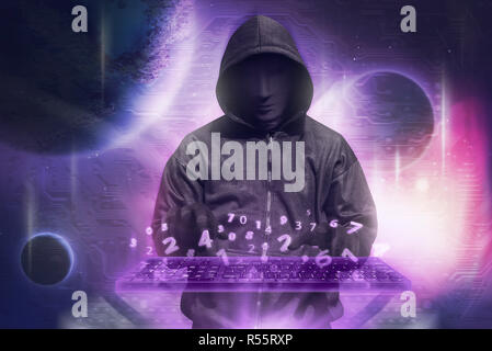 Hacker in mask typing keyboard hacking binary data Stock Photo - Alamy