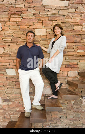 Man standing on steps while locking door of apartment Stock Photo - Alamy