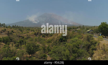 slopes volcano with forest fire, farmland at foot of the volcano Agung ...
