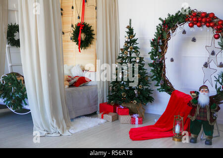 Beautiful Christmas tree, comfortable bed and festive decor in bedroom ...