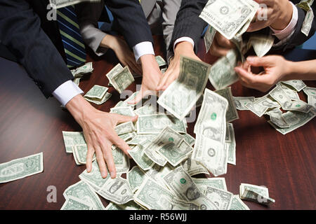 Businesspeople grabbing money Stock Photo - Alamy