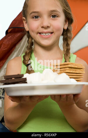 Photo of adorable cheerful girl toothy smile arm hold paper heart card ...