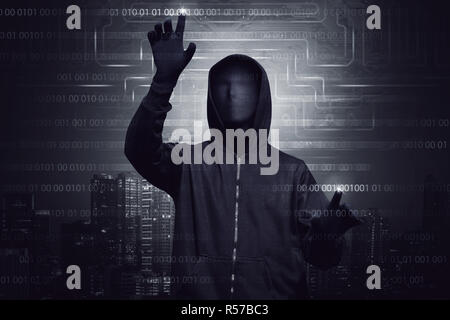 Hooded hacker with mask using virtual screen to hacking system security ...
