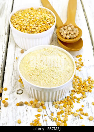 Flour pea and split pease in bowls on light board top Stock Photo - Alamy