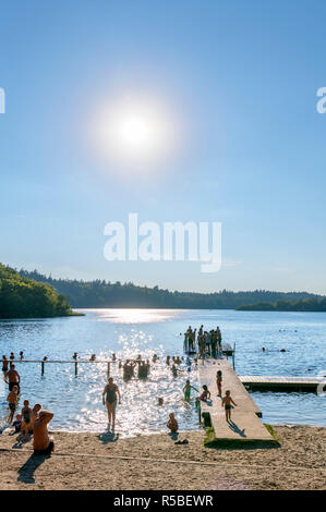 Danish Lake District (Søhøjlandet). Bathers on the shore of Lake Almind ...