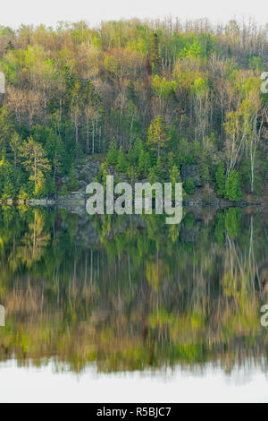 Spring reflections in Simon Lake, Greater Sudbury, Ontario, Canada ...