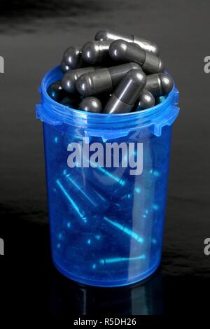 Overflowing Bottle of Pills Stock Photo - Alamy