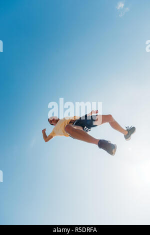 Free runner trains parkour while jumping in the air Stock Photo - Alamy