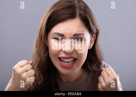 Portrait Of An Angry Young Woman Clenching Her Teeth Stock Photo - Alamy