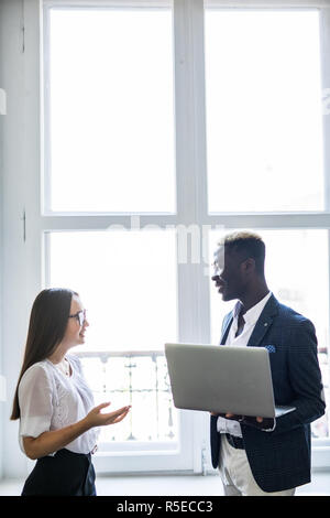 young pretty asian, afro woman posing cheerful together on brown ...