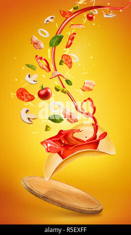 Tasty pizza with falling ingredients on white background Stock Photo ...