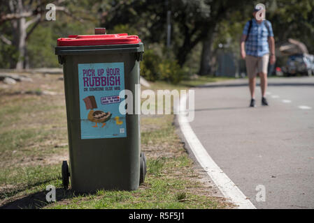 The litter bin in public park and litter around Stock Photo - Alamy