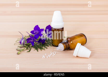 Homeopathic remedy with blooming aconite Stock Photo - Alamy