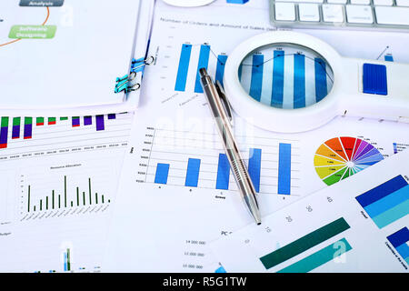 Magnifying glass, graph paper and keyboard on the table Stock Photo - Alamy