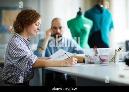 Woman tailor working at her desk Stock Photo - Alamy