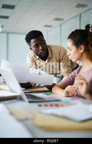 Young businessman working with documents looking through papers in ...