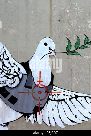 Graffiti West Bank Dove of Peace wearing bullet proof vest Stock Photo ...