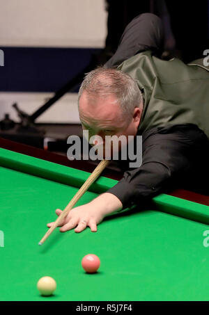 John Higgins in action against Judd Trump (not pictured) on day seven ...