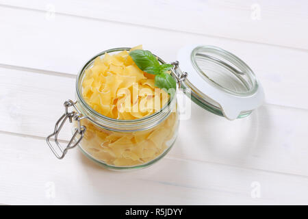 jar of quadretti - square shaped pasta on white wooden background Stock ...