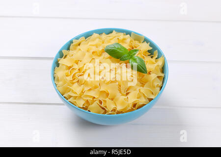 bowl of quadretti - square shaped pasta on checkered place mat - close ...