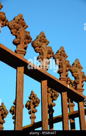 Old wrought iron rusty railings against blue sky Stock Photo - Alamy