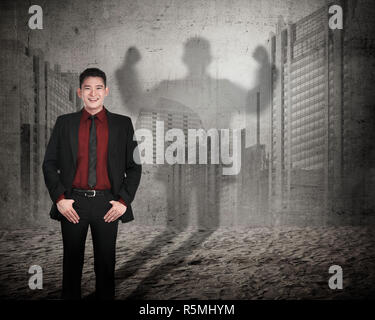Asian business man casting a shadow of strength Stock Photo - Alamy