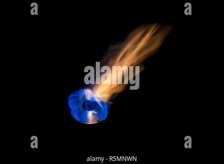 CD burning with a colorfull blue flame isolated on black background ...