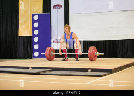 Ready, steady, go. Muscular man, runner, athlete in motion, standing on ...