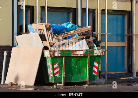 Overloaded skip on a building site - waste segregation Stock Photo - Alamy