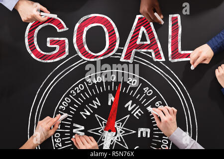 Group Of People Looking At Compass Goal Guidance Concept Stock Photo ...