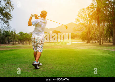 Golfer finishing his driver swing Stock Photo - Alamy