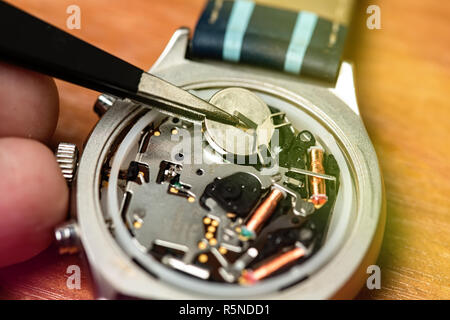 Replacing the battery in the electronic clock Stock Photo - Alamy
