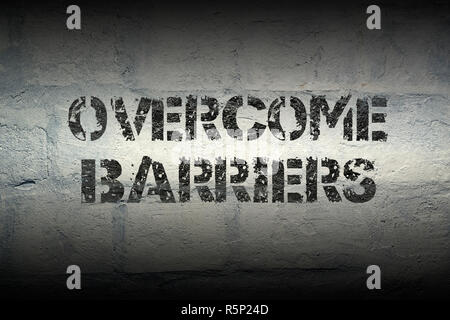 overcome obstacles stencil print on the grunge white brick wall Stock ...