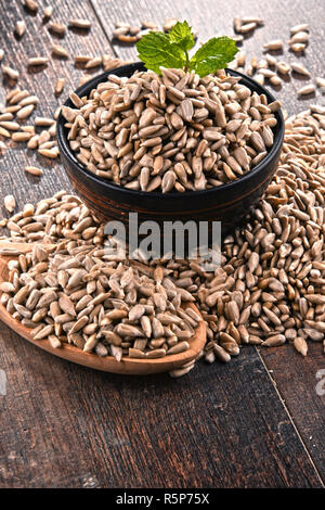 Composition with bowl of shelled sunflower seeds on wooden table Stock ...