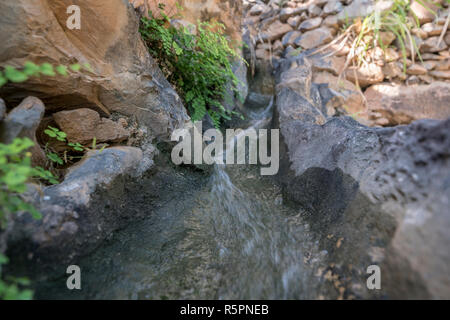 Traditional falaj irrigation system in the mountain village of Misfat ...