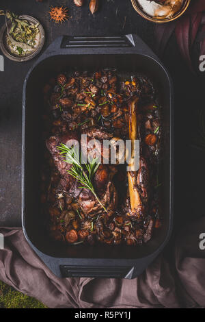 A piece of meat grilled in a cast-iron pan with vegetables, closeup ...
