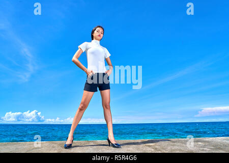 Beautiful woman posing -open legs, sitting on chair, looking at camera ...