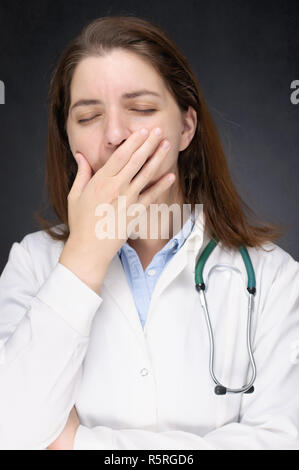 Woman doctor tired yawning Stock Photo - Alamy