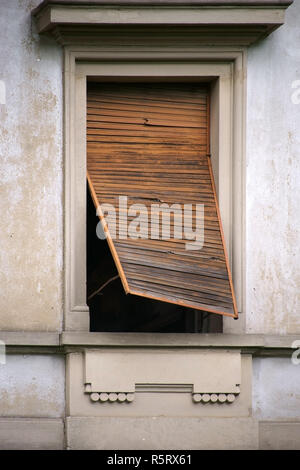 detail of old wooden shutter blind with rotten and cracked white paint ...
