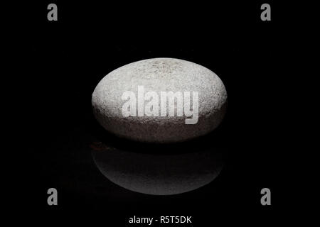 Single stone - dark background - zen concept Stock Photo - Alamy