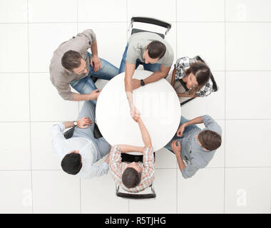 top view. handshake colleagues at the round table Stock Photo - Alamy