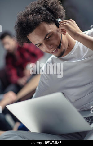 Laughing african american hipster software developer at computer at ...