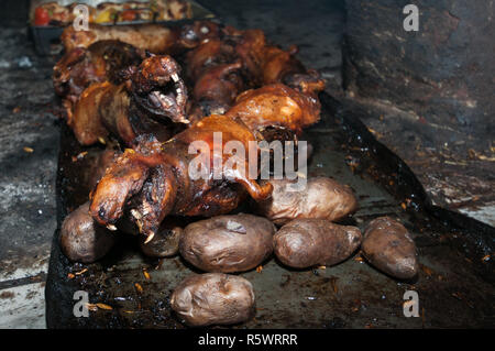 Peruvian woman cooking a rat Stock Photo - Alamy