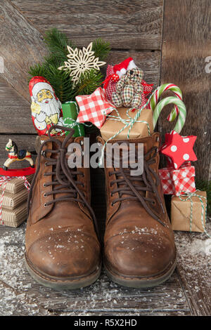 Boots with gifts and sweets Stock Photo - Alamy