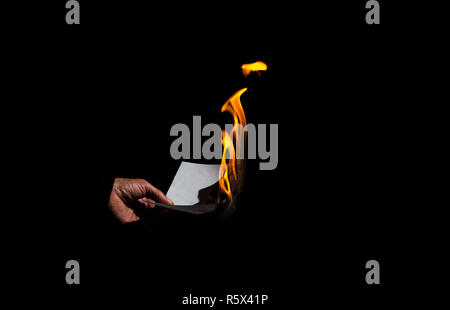 burning piece of paper on black background Stock Photo - Alamy